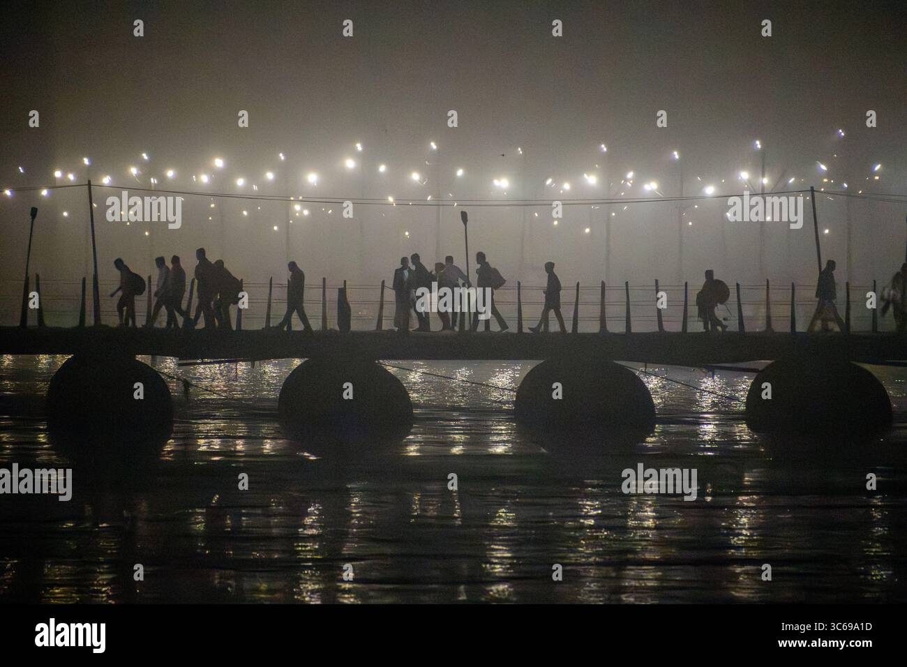 Crossing pontoon bridges by night at the Kumbh Mela, Prayagraj, India ...