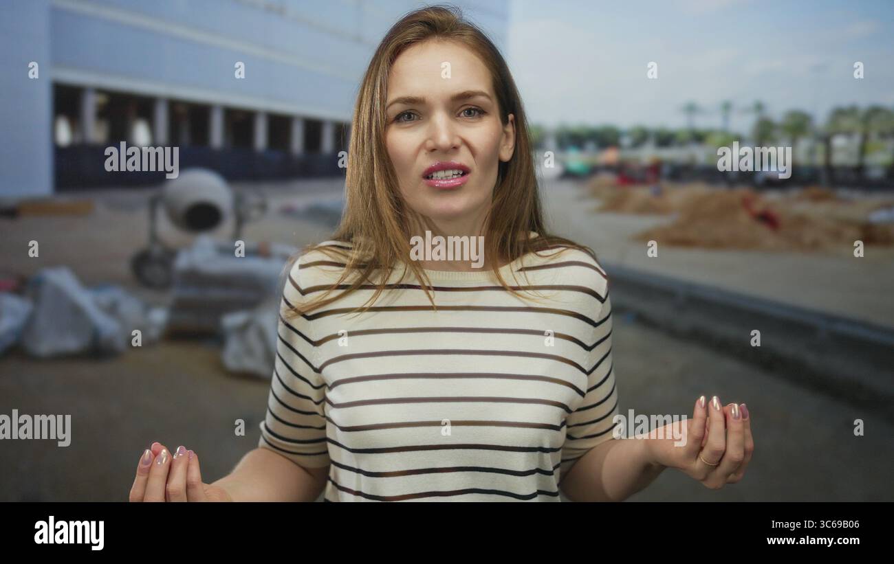 Woman clearly grimaces with pursed lips and lifts hand near chest in ...