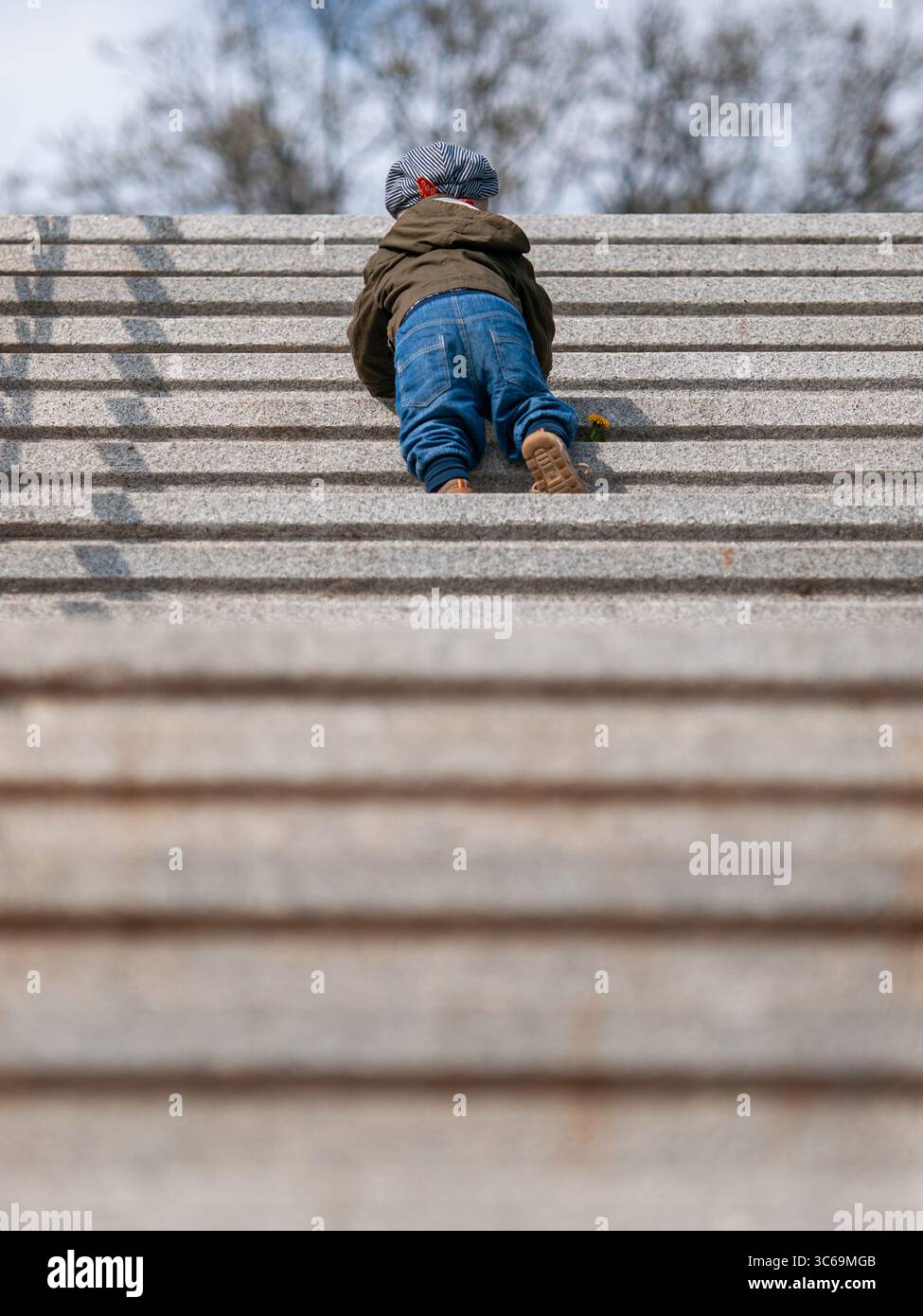 A child climbs up stone steps, symbolizing determination, life journey ...