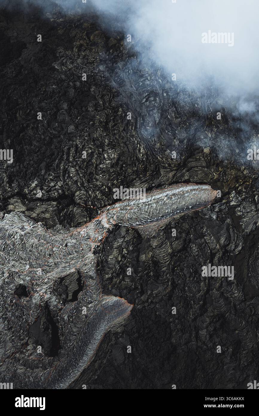 Aerial view of a volcanic landscape where dark, hardened lava flows ...