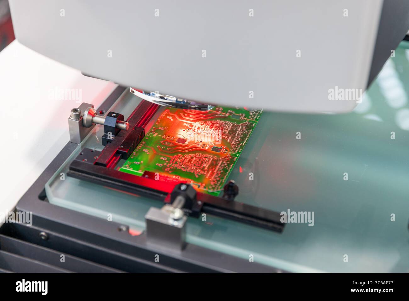 Close-up of an automated optical inspection (AOI) machine examining a printed circuit board (PCB ...