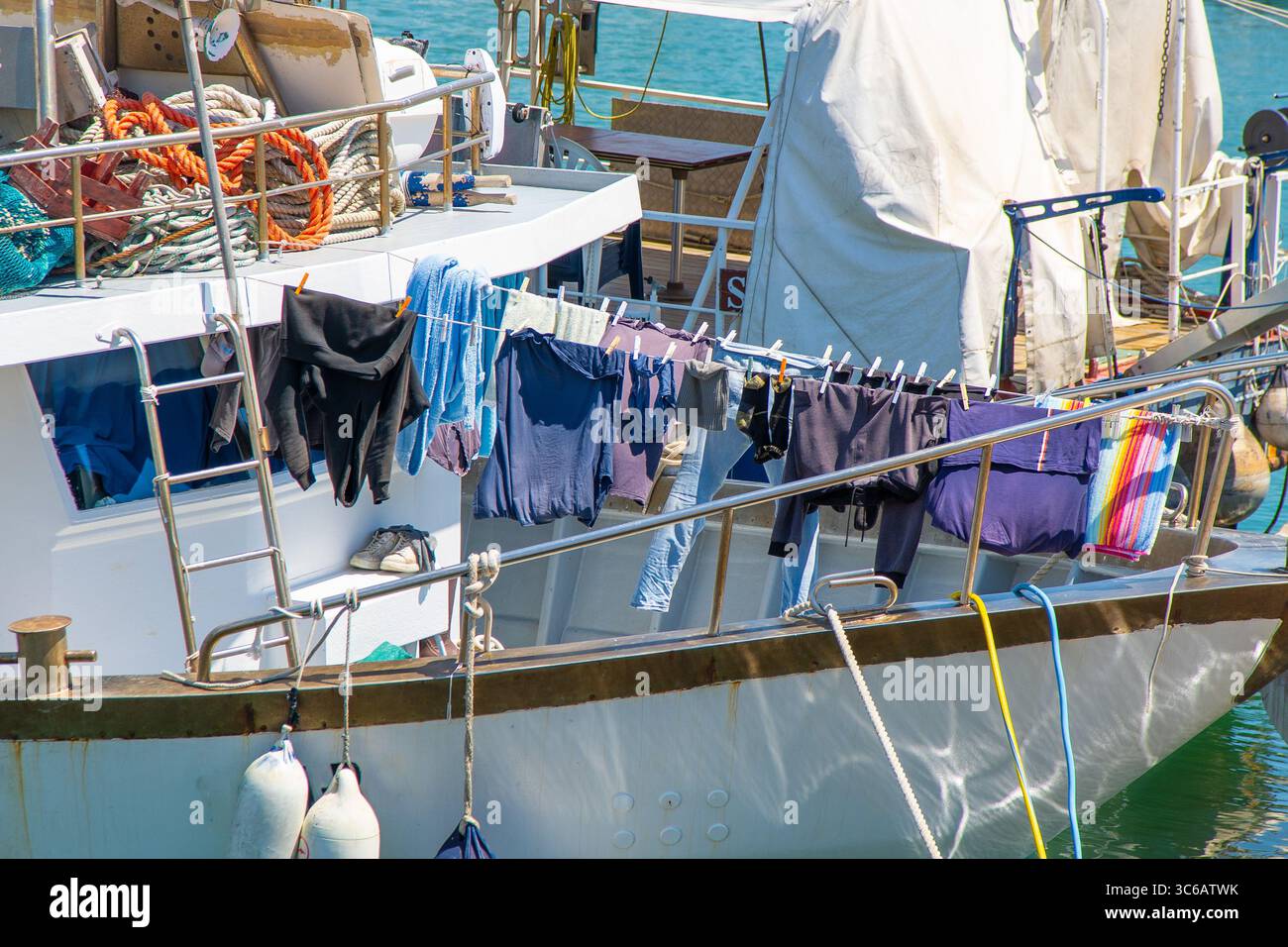 Life on a boat. Washing clothes on a yacht. Clothes drying on a rope ...