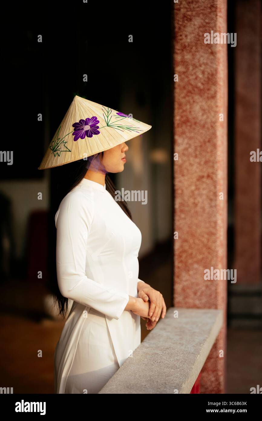Vietnamese woman in ao dai at Hainan Chinese Buddhist Temple Hoi Quan ...