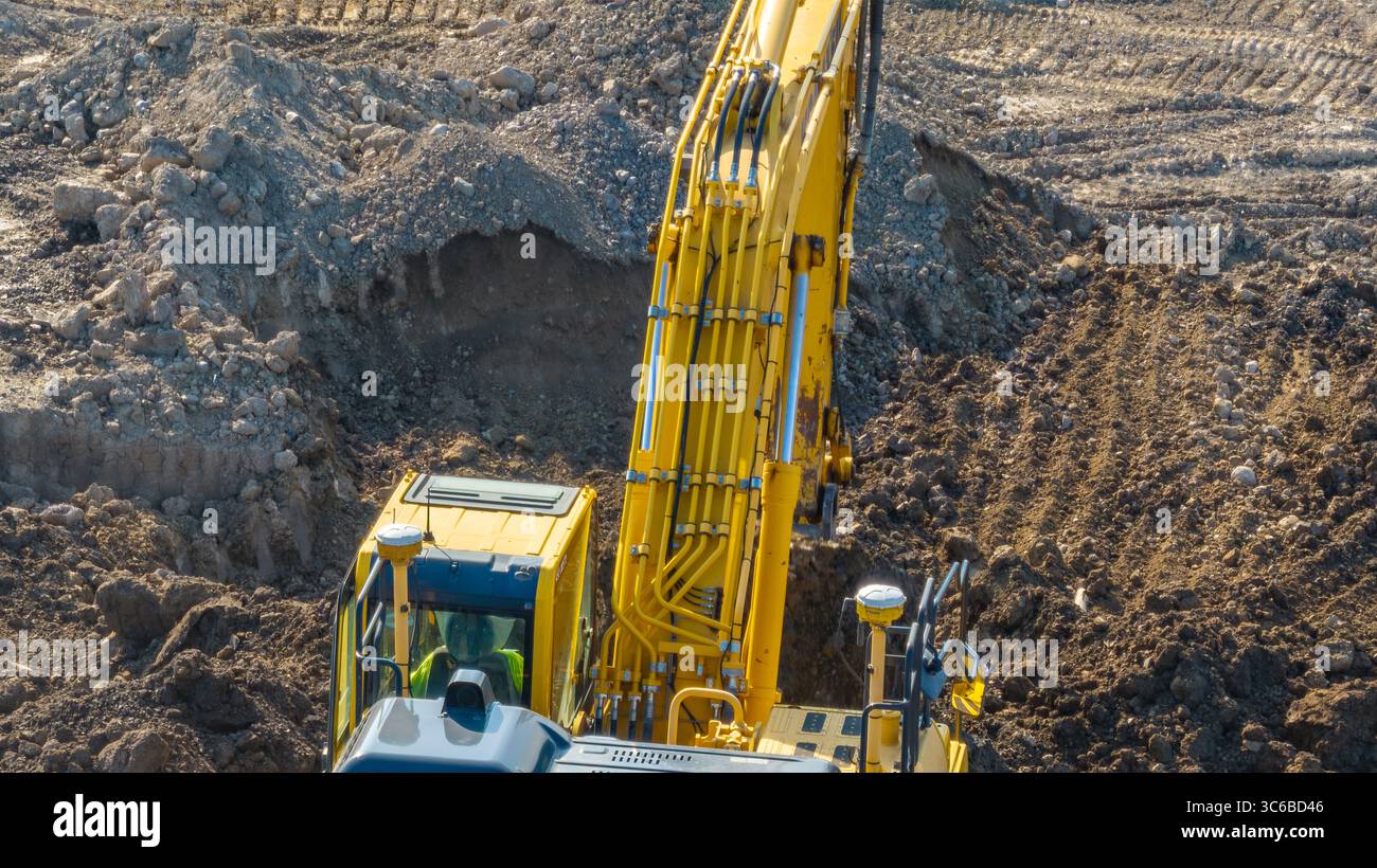 Aerial, overhead image of a excavator working on construction site ...