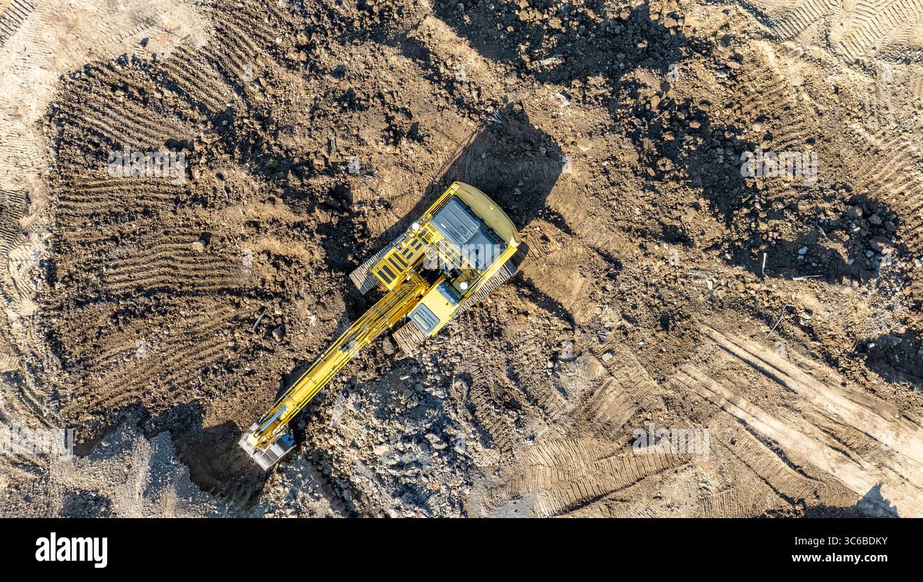 Aerial, overhead image of a excavator working on construction site ...