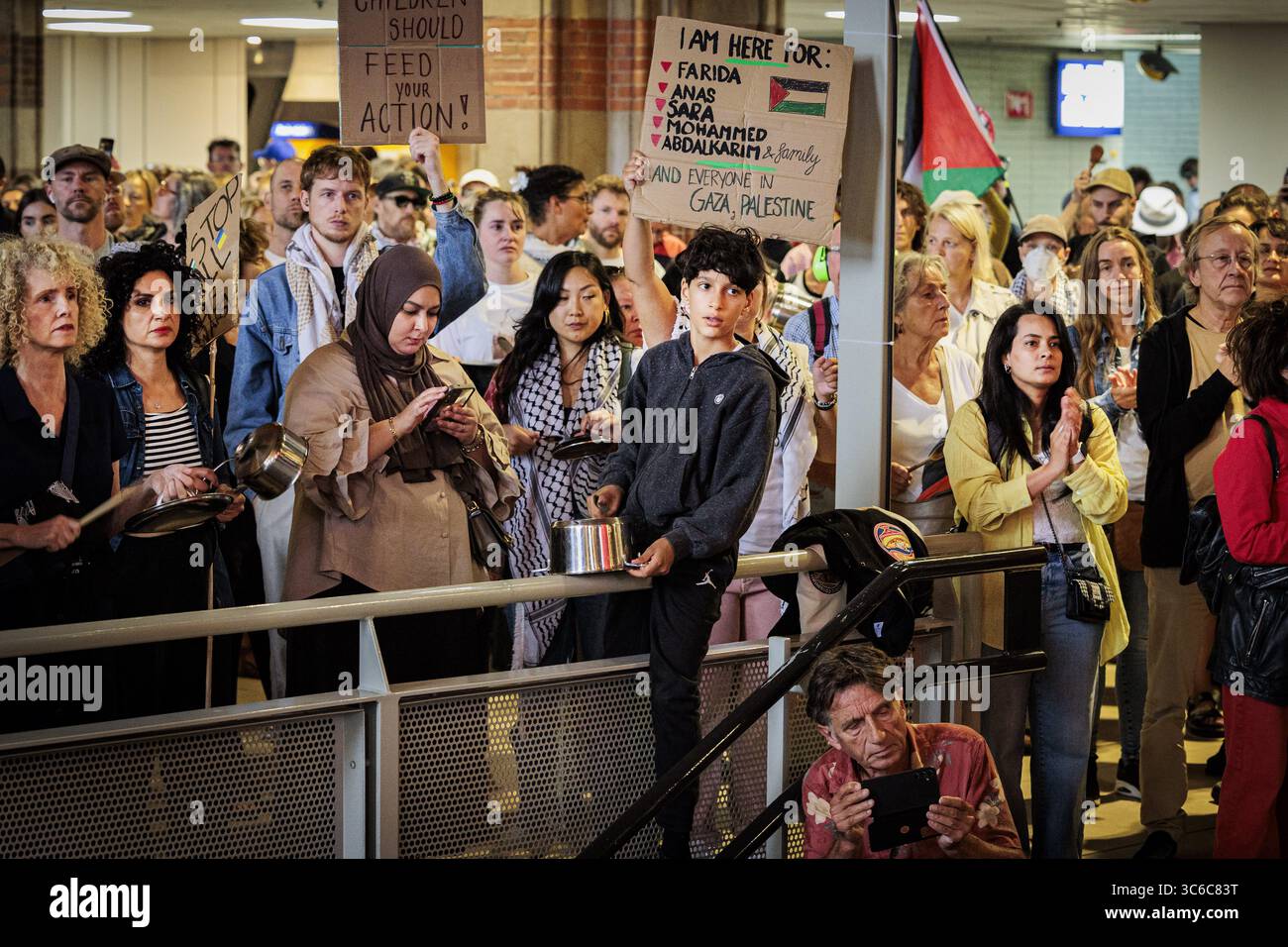 AMSTERDAM - Participants during a protest at Amsterdam Central Station ...