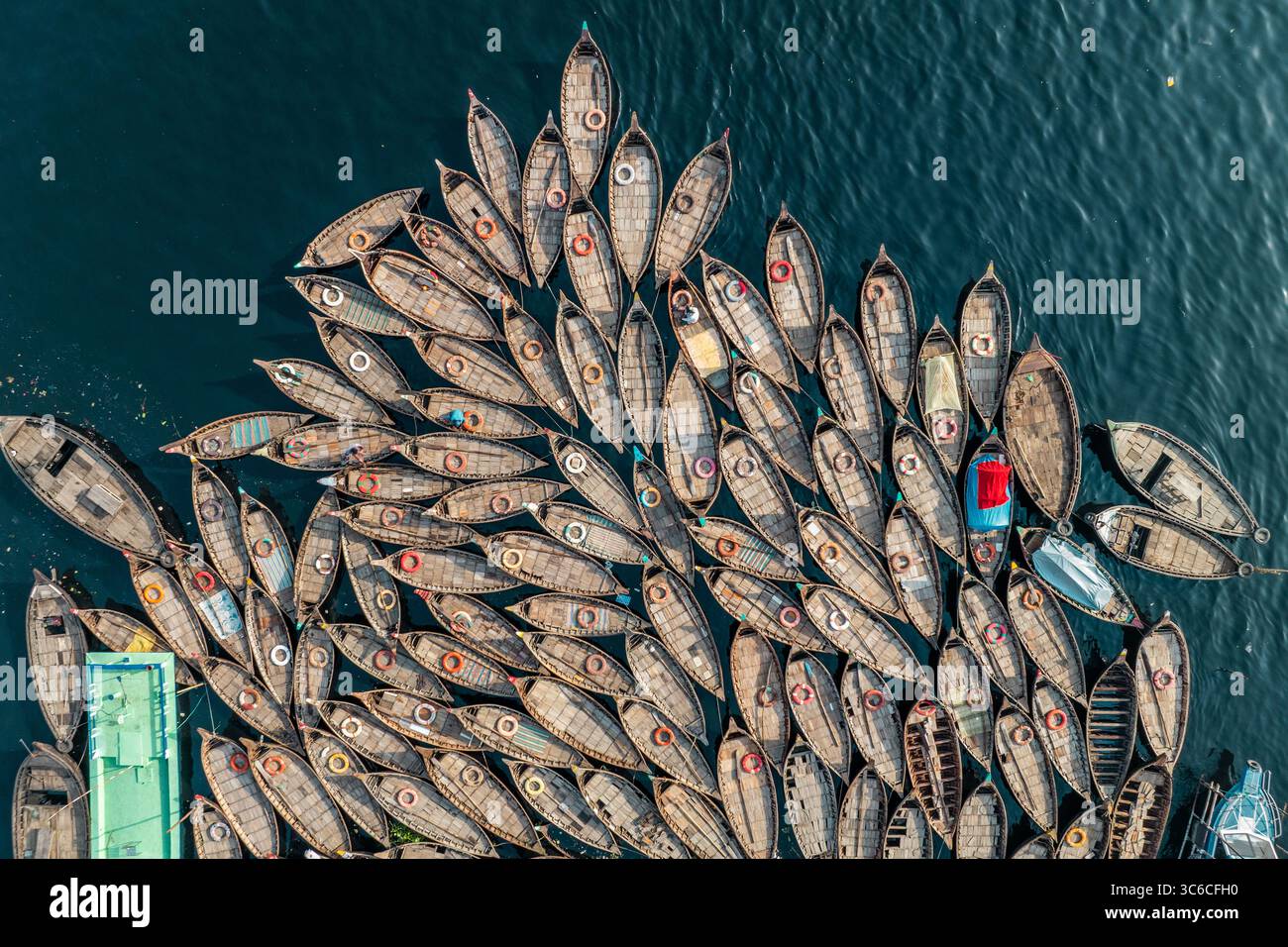 Aerial view of traditional boats clustered together on the shimmering ...