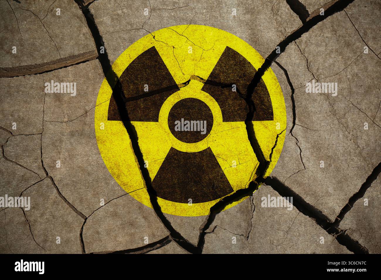 Yellow radioactive sign on cracked dry earth, top view. Radiological ...