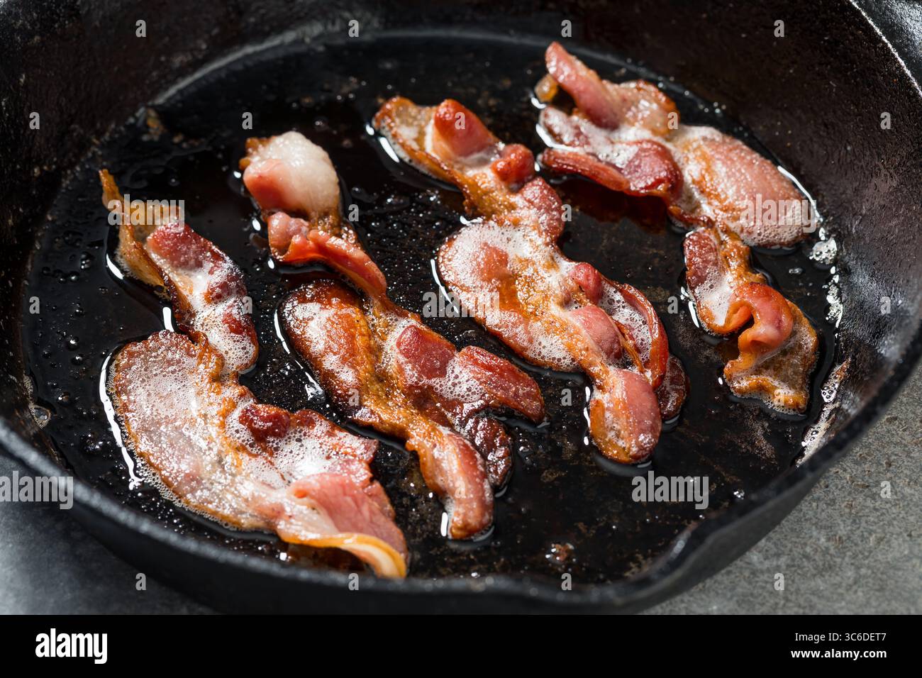 Greasy Fatty Cooked Crispy Bacon in a Skillet Stock Photo - Alamy
