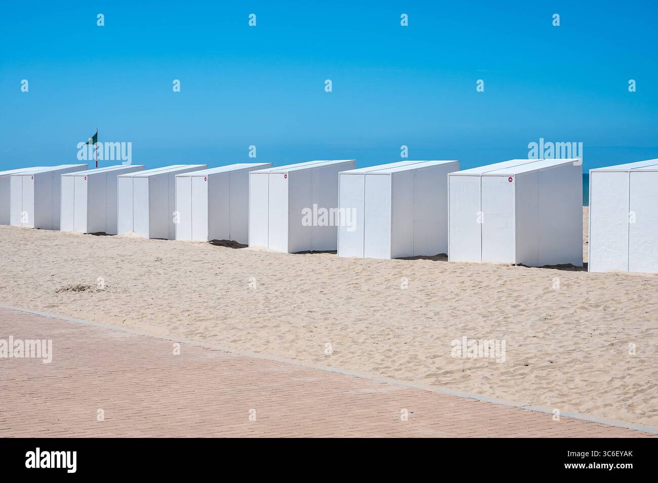 Row oof white beach cabines at the seaside in Koksijde bad, West ...