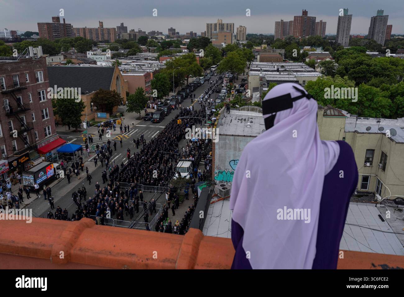 A person watches the funeral of officer Didarul Islam near the Parkchester Jame Masjid mosque ...