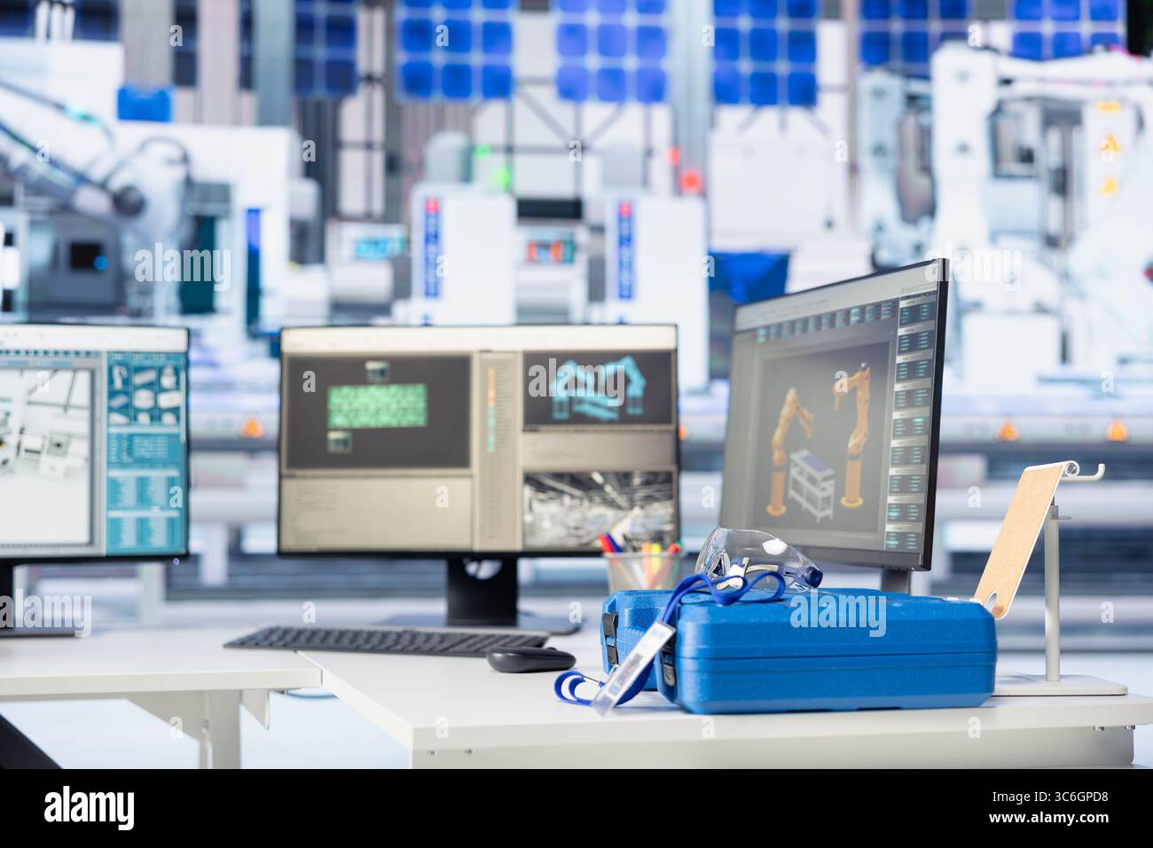 PC on desk in empty photovoltaics factory next to tool box monitoring system performance ...