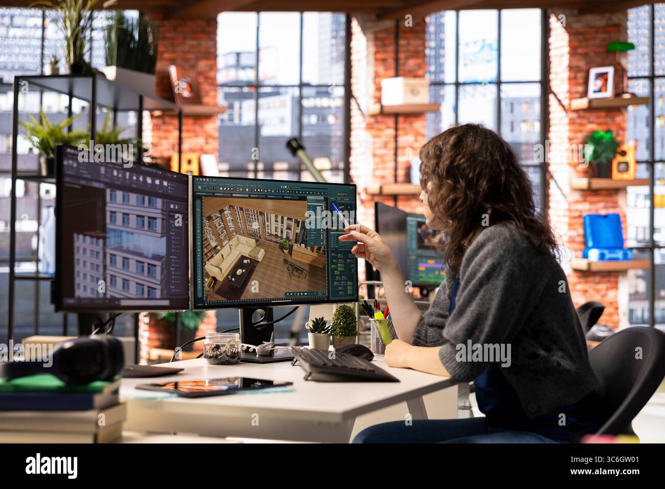 Female designer uses professional 3d hi-res stock photography and ...