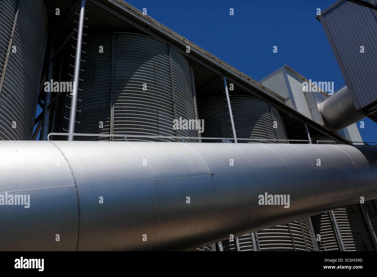Abstract detail images of large pipes and silos in an industrial ...