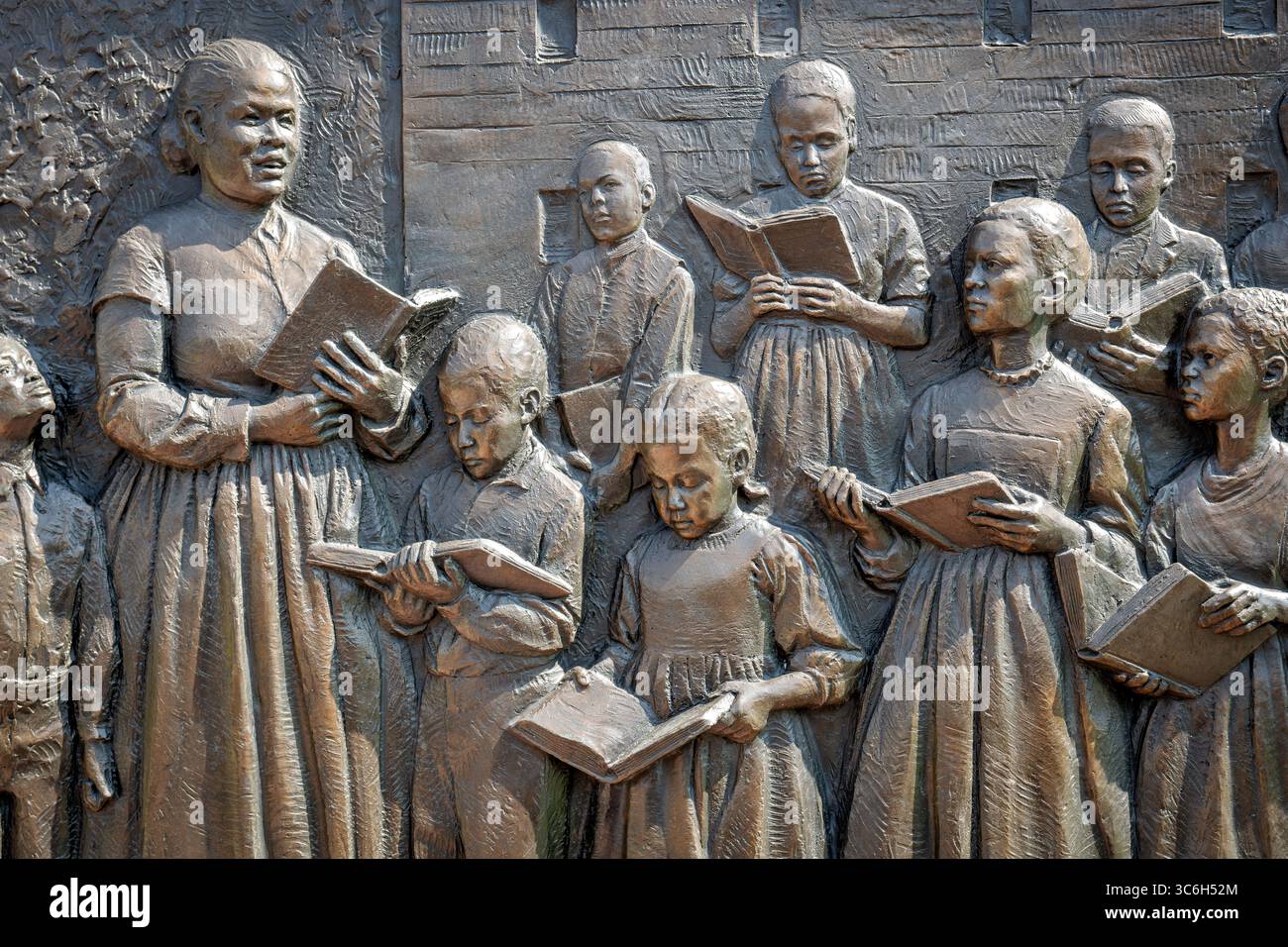 ALEXANDRIA, Virginia — A bronze relief sculpture depicting children ...