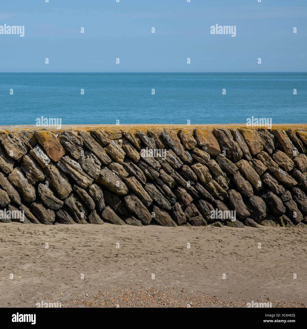Layers of the sand, stone sea wall, sea and sky at Sandy Beach in ...