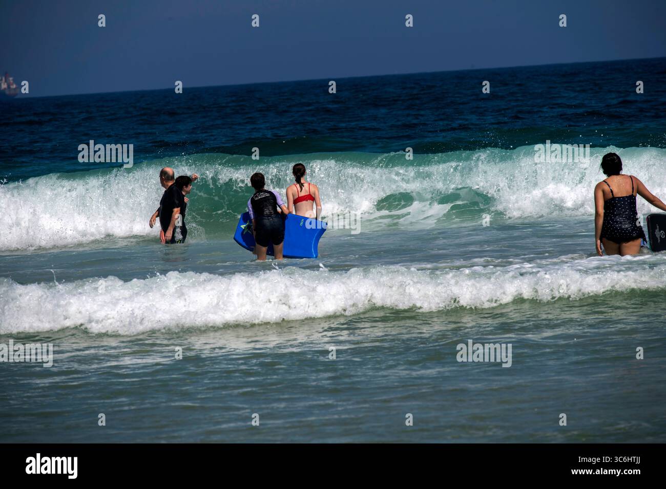People in the ocean with waves and bodyboards at the Caves Beach ,NSW ...