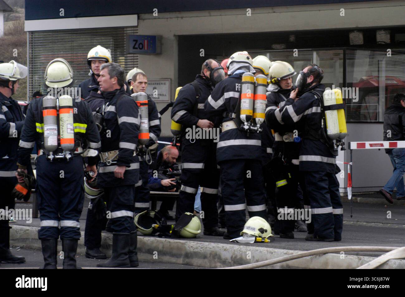 firefighter wearing protective clothing and respirator mask against ...