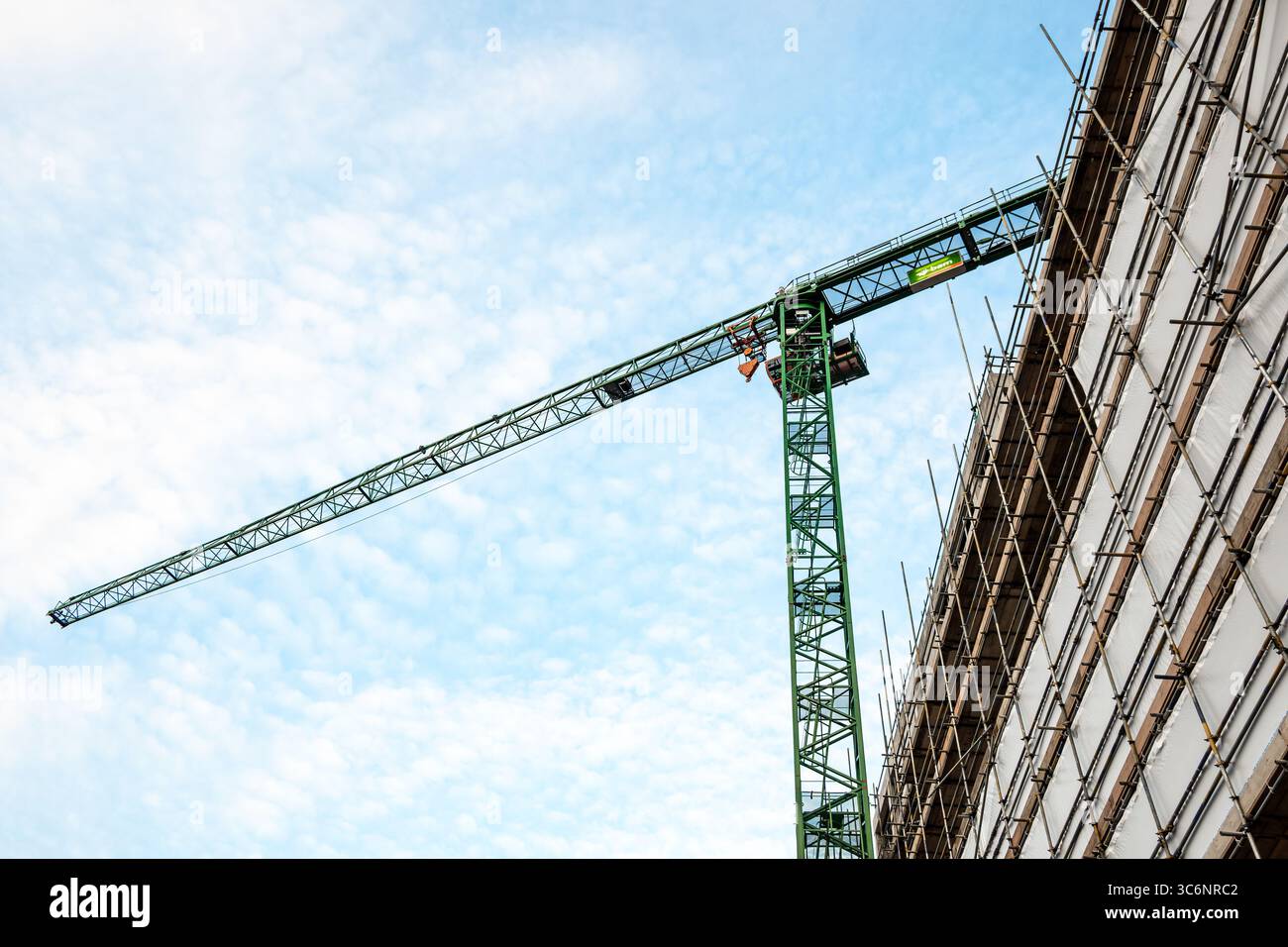 July 25, 2025 Cork, Ireland A tall crane towers over a partially built ...