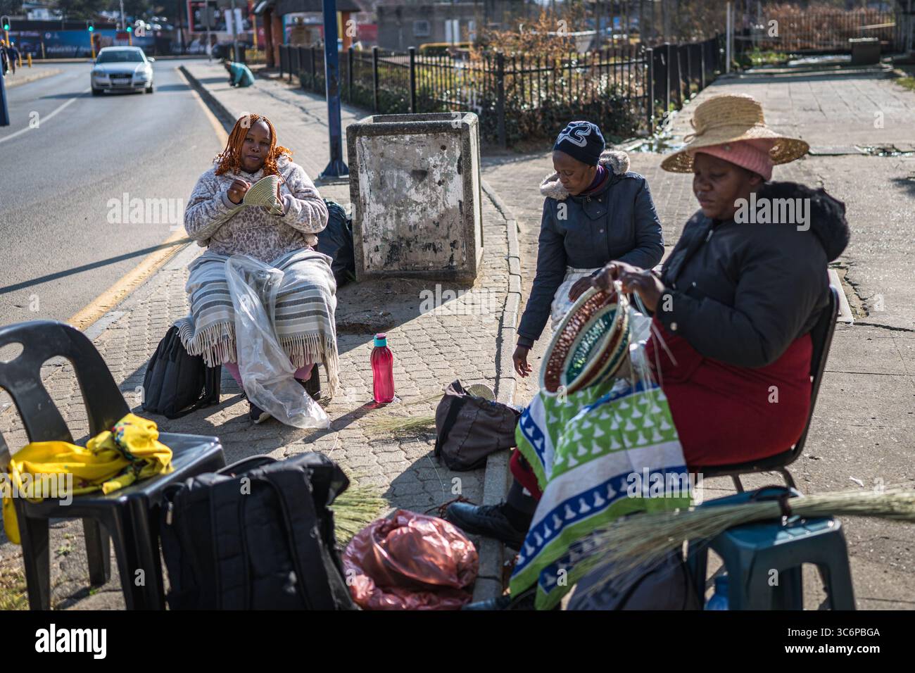 Maseru. 30th July, 2025. Vendors make traditional straw hats of Basotho ...