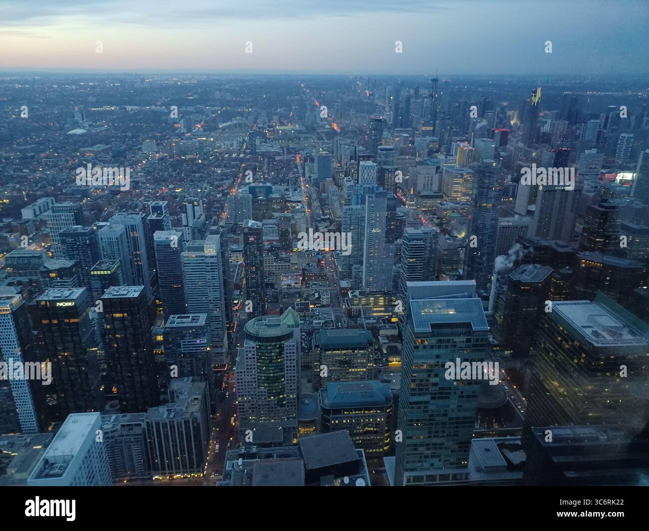 Toronto, ON, Canada – November 27, 2024: The city lights begin to glow ...