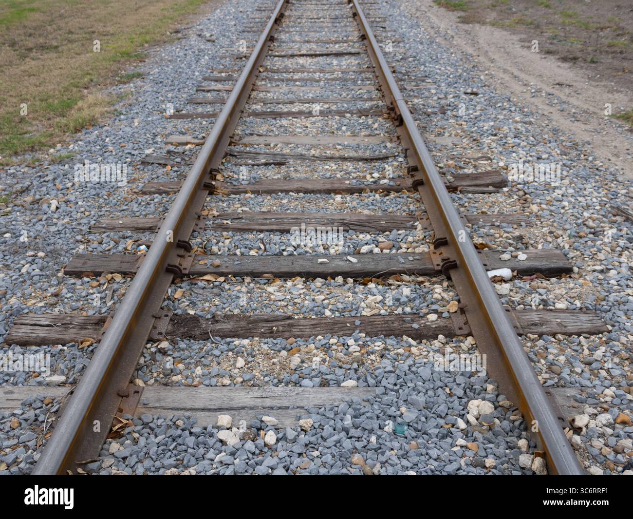 Photograph of railroad tracks extending into the distance, symbolizing travel, direction, and ...