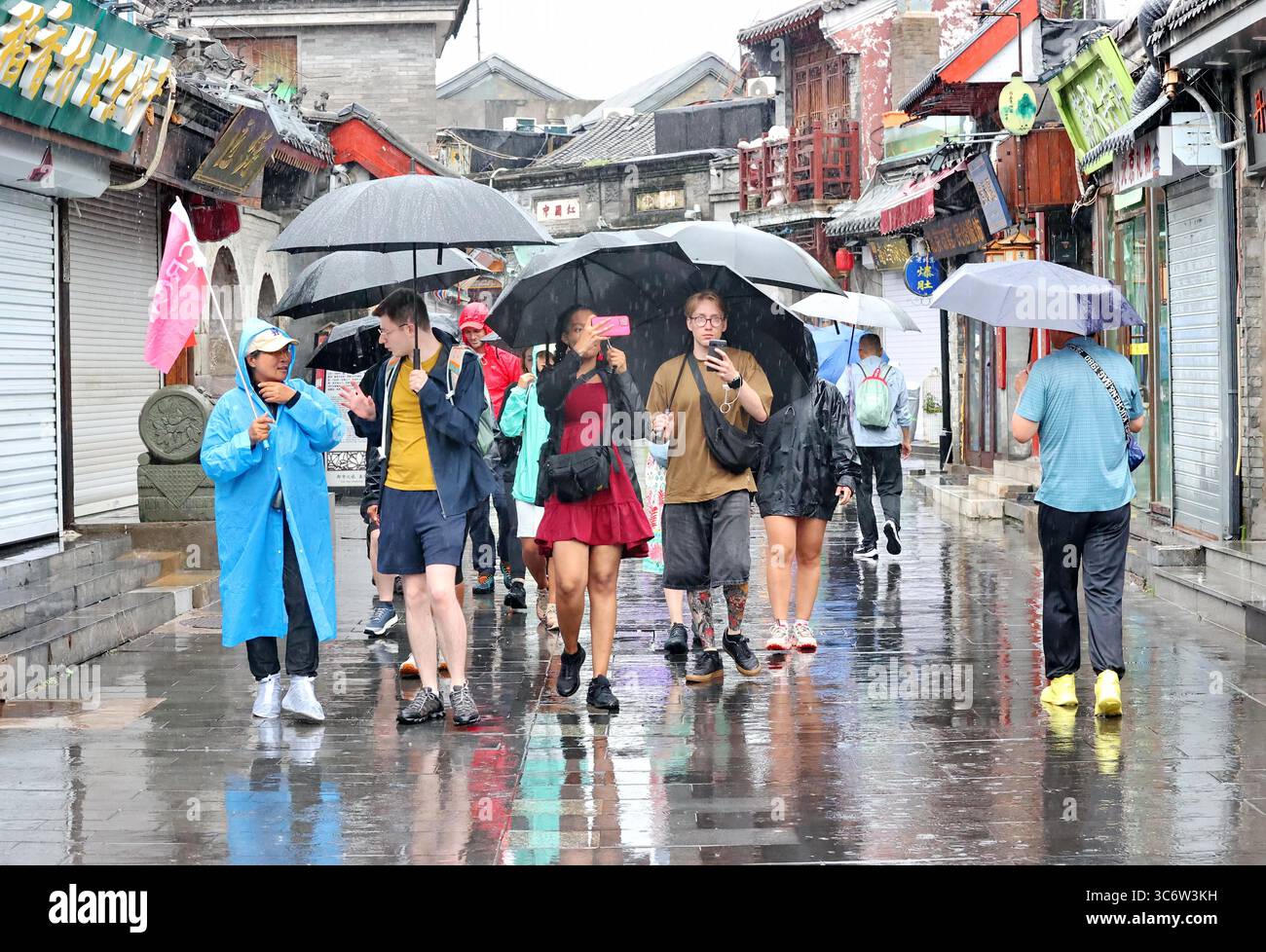 Tourists visit Shichahai scenic area in the rain in Beijing, China, 29 ...