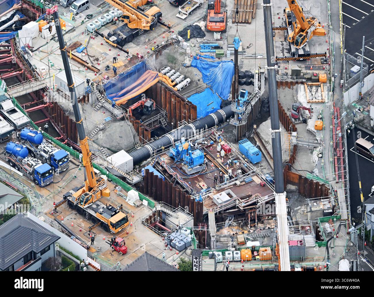 An aerial photo shows the site of a road collapse accident in Yashio ...
