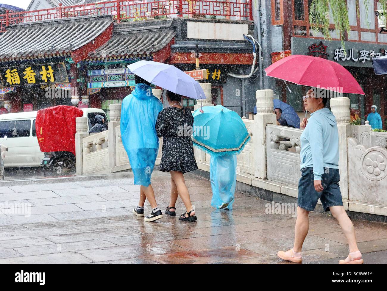 Tourists visit Shichahai scenic area in the rain in Beijing, China, 29 ...