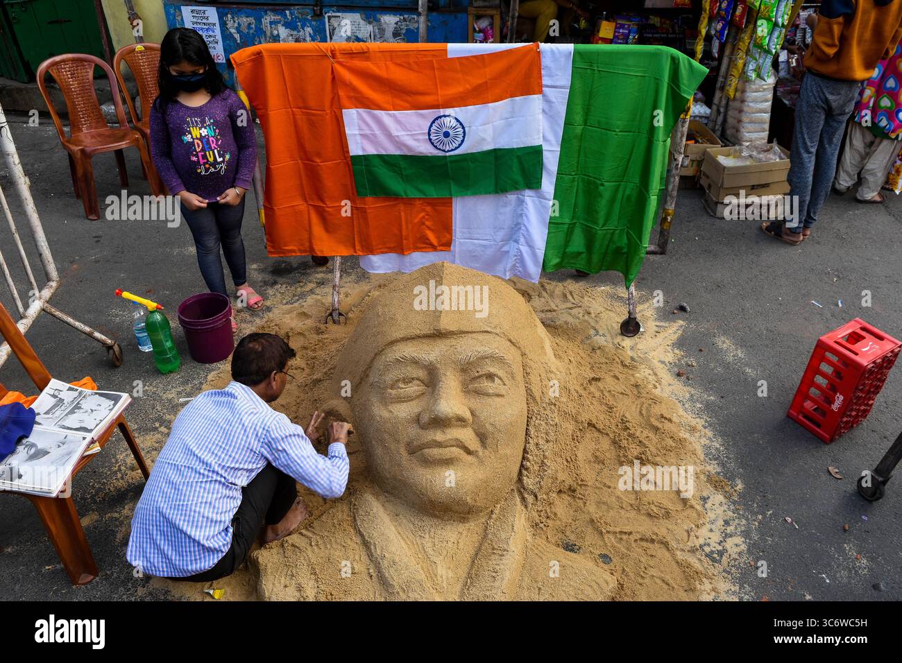 January 21, 2021, Kolkata, West Bengal, India: An artist gives final touches to a sand sculpture ...