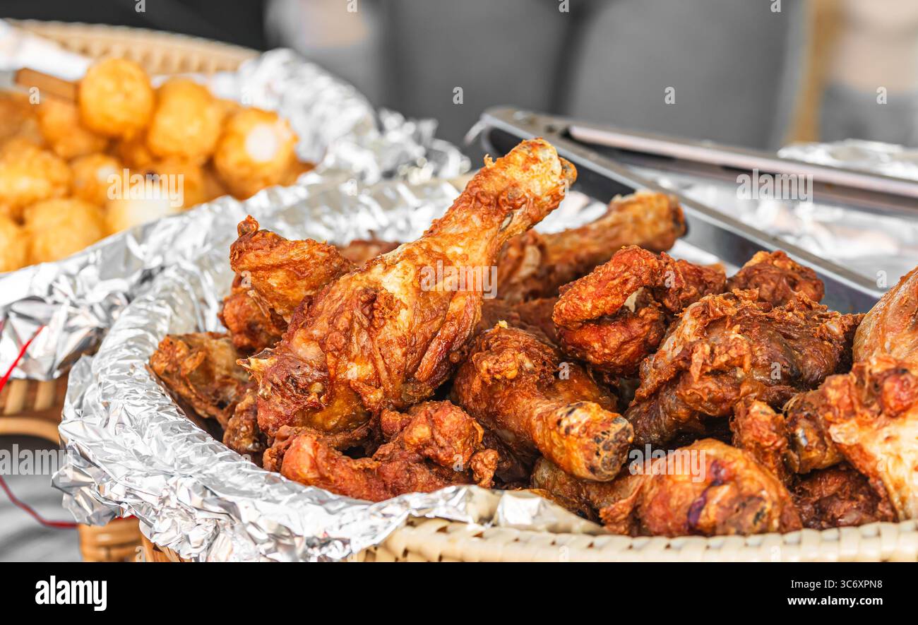 Plate with fried chicken wings at a street food stall, asian street ...