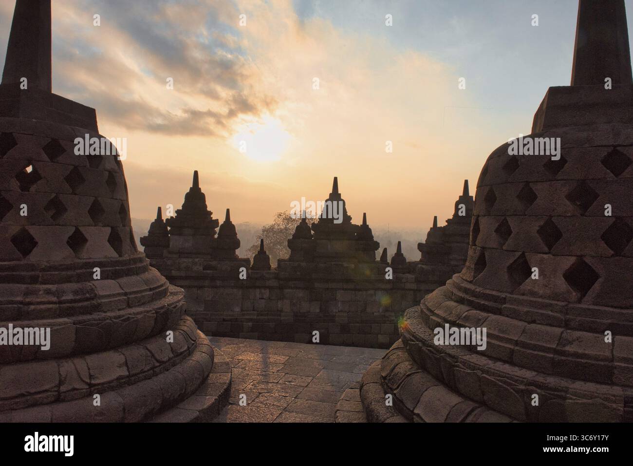 The silhouettes of stupas of the Borobudur temple in the morning light ...