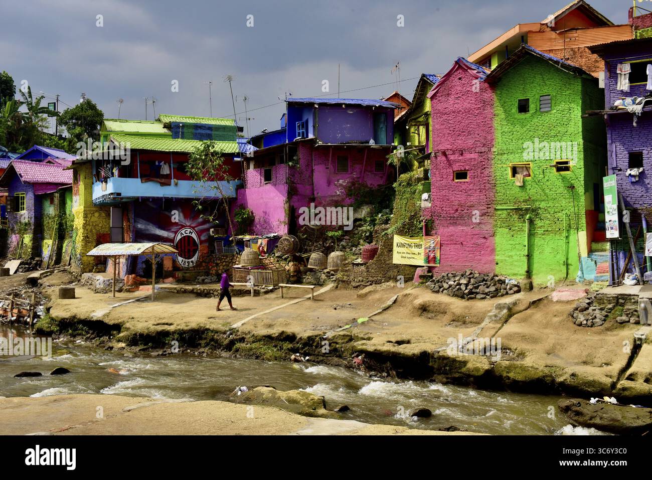 Colourful houses by a river in a lively urban setting. The atmosphere ...