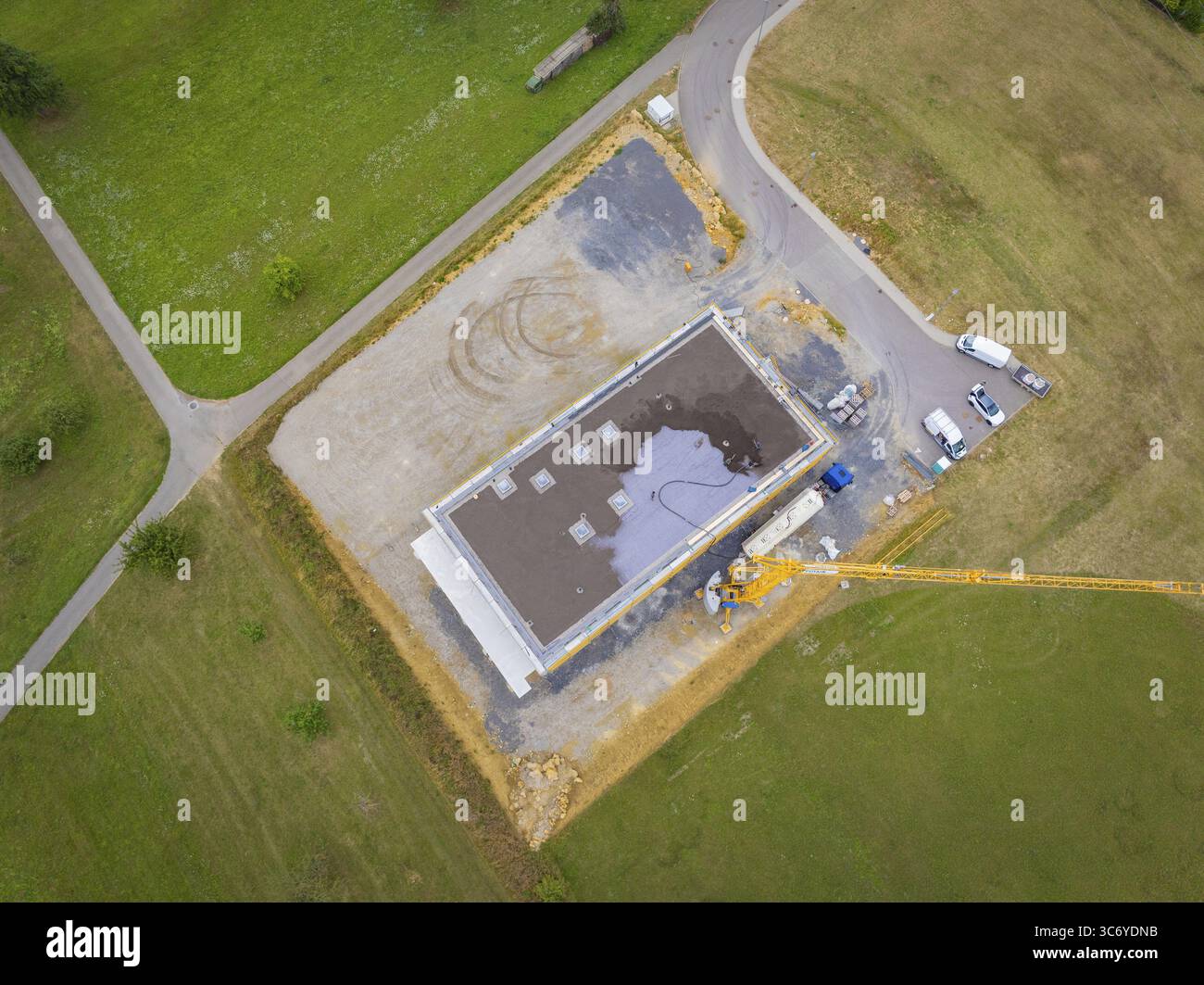 Aerial view of a construction site area with vehicles and a crane next ...