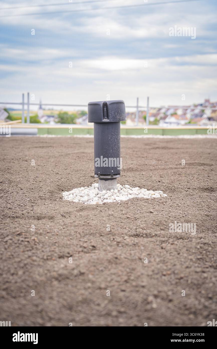 Single ventilation shaft on a green roof with city in the background ...
