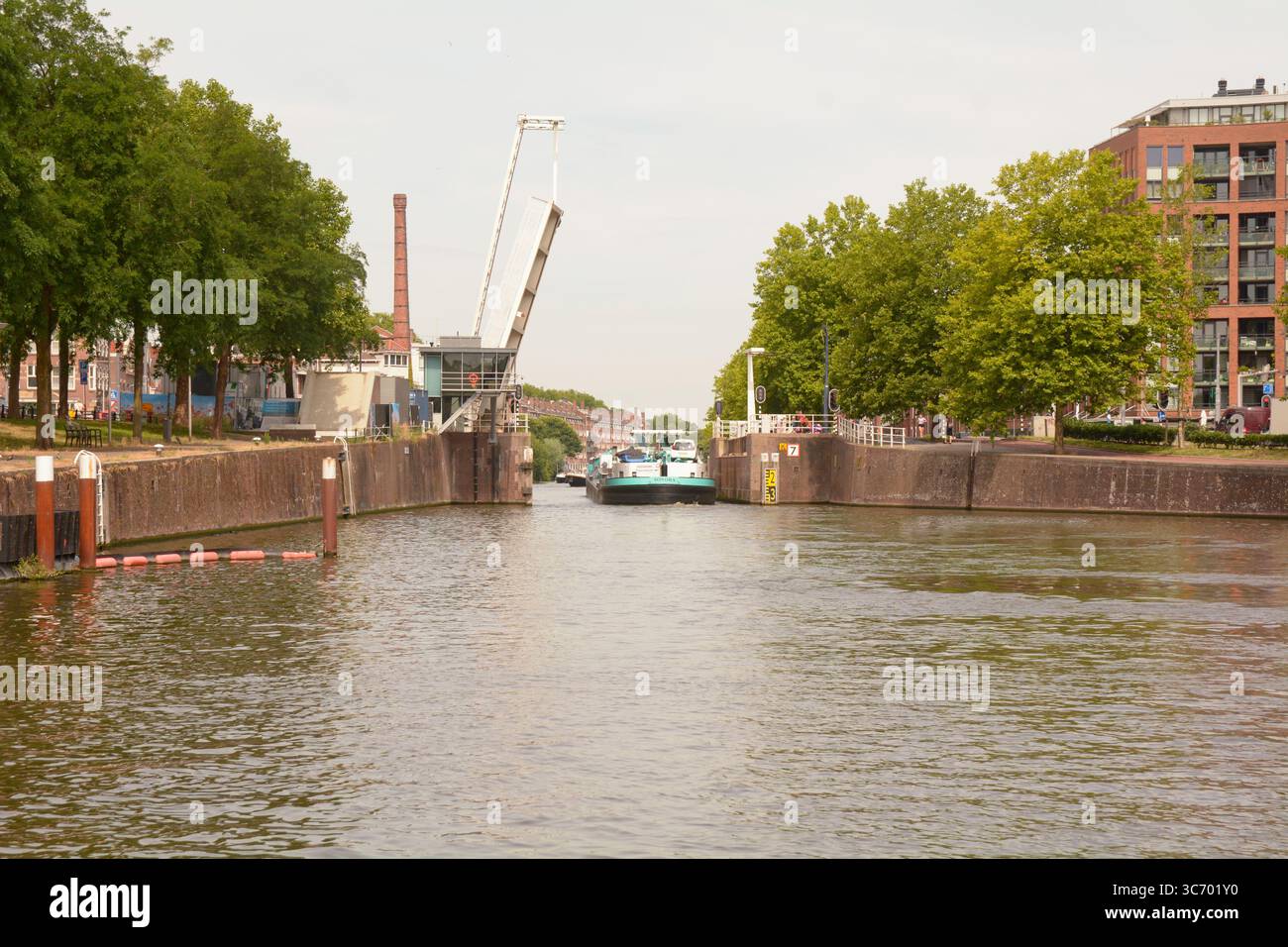 A bascule bridge over one of Rotterdams many waterways rising to allow ...