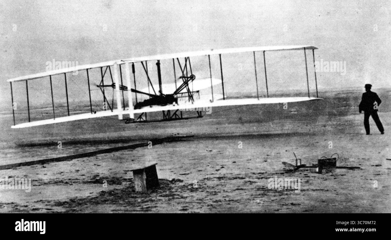 Wilbur Wright watches as Orville Wright pilots the first powered flight ...