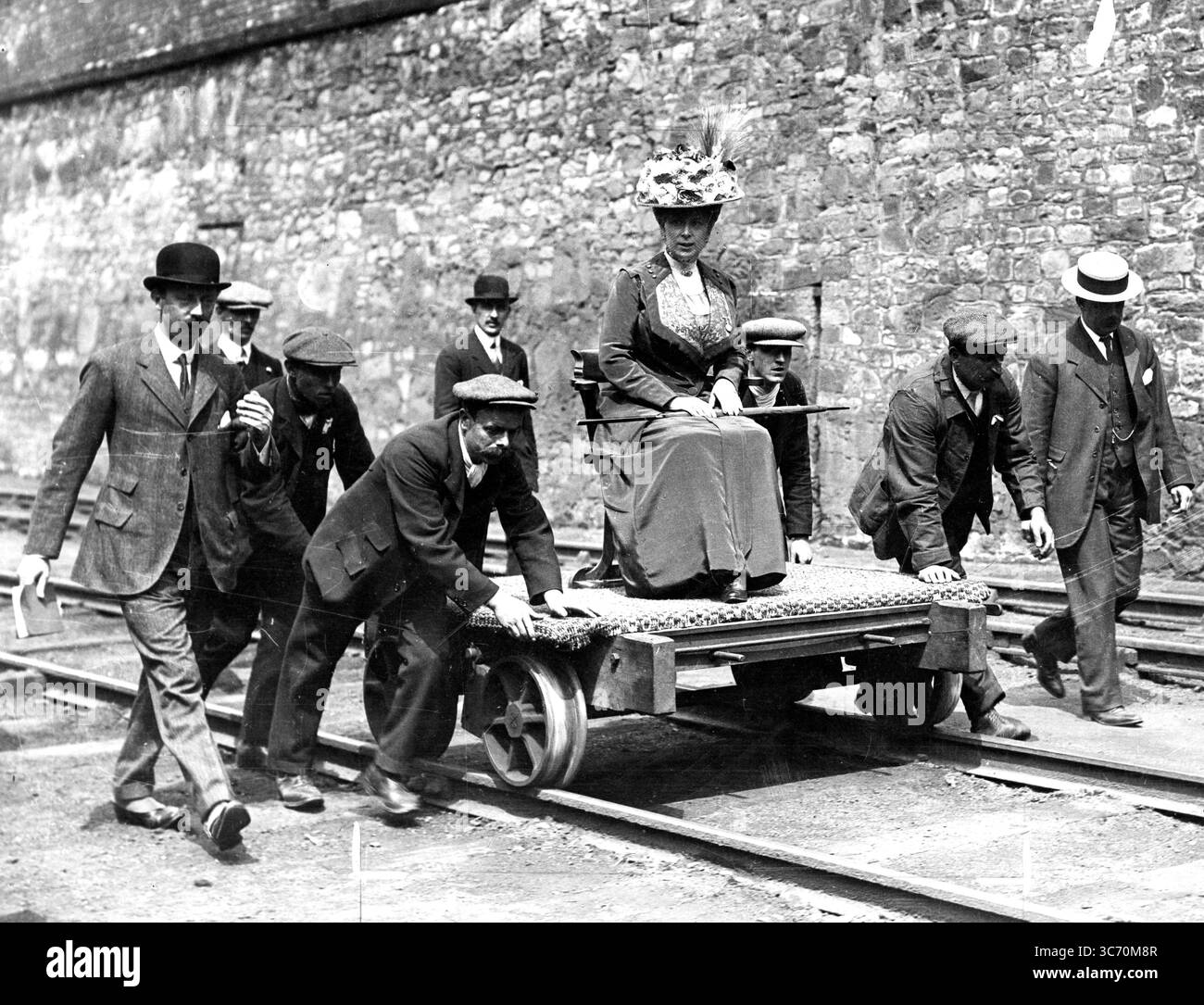 Queen Mary pictured being pushed on a coal trolley after a tour of the ...