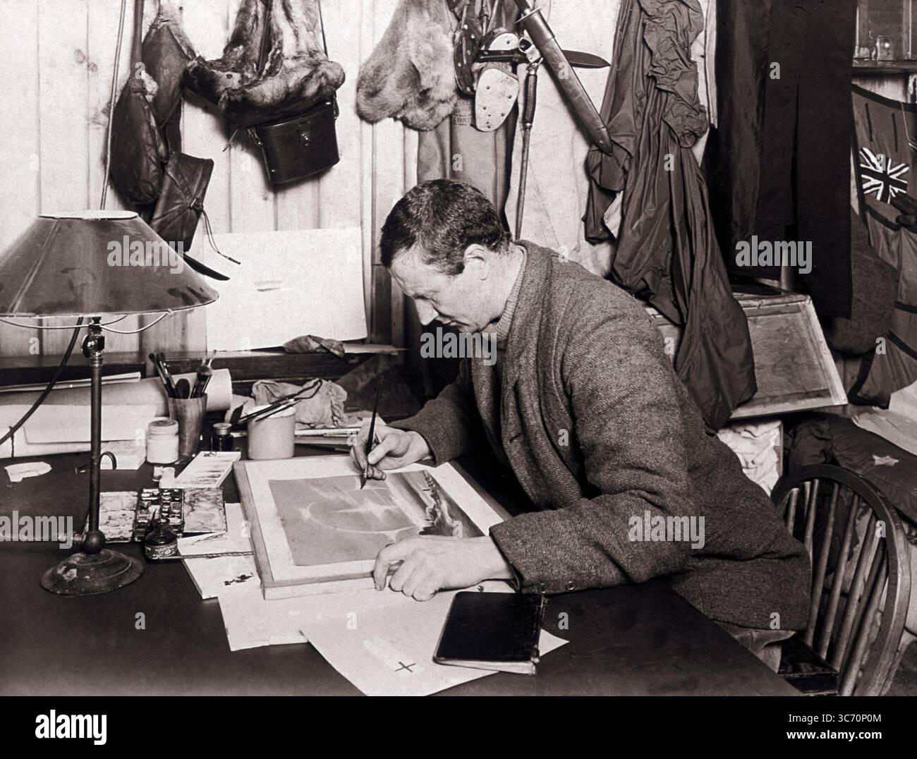 Polar exploration 1911. Captain Scott at his desk in the base camp Stock Photo - Alamy