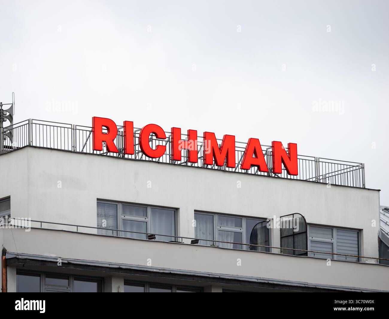 Richman logo sign on the rooftop of a building in Prague. Advertisement ...
