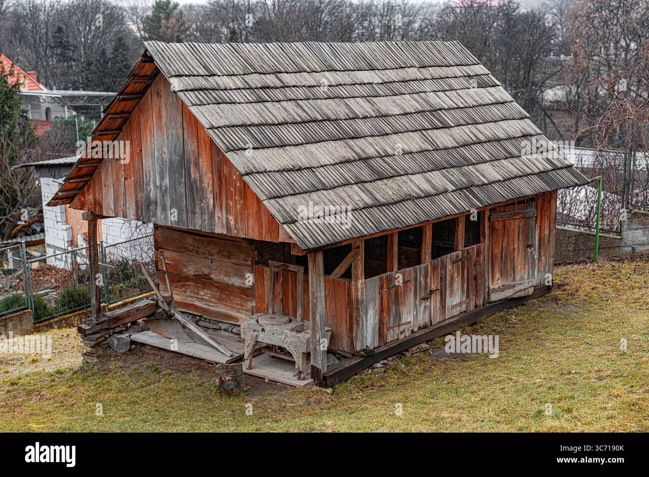 Traditional wooden log cottage with a thatched roof and small windows ...