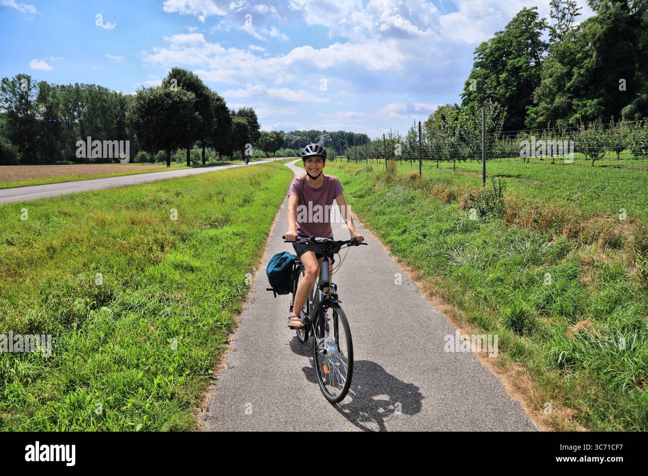 Woman cyclist exploring Austria in summer. Danube Cycle Path ...