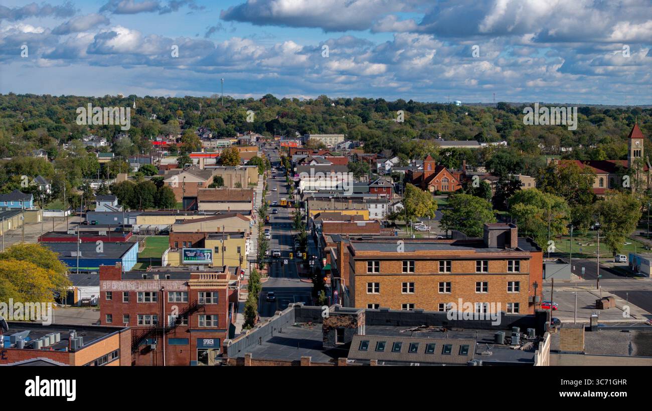 Aerial view of a vibrant street flanked by brick buildings and church ...