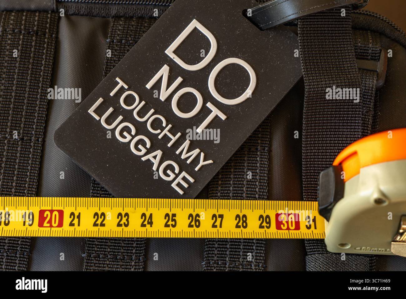 Measuring the backpack size with a tape measure before traveling by ...