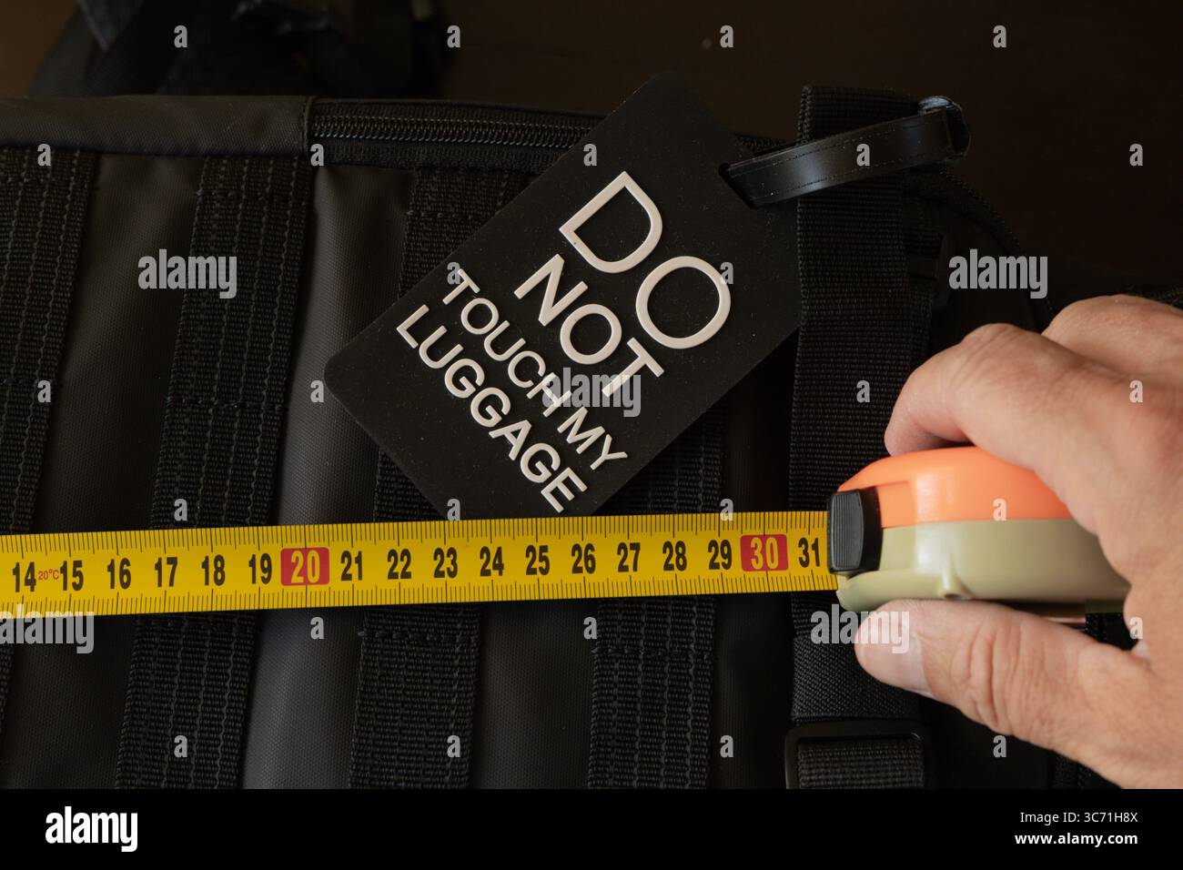 Measuring the backpack size with a tape measure before traveling by ...