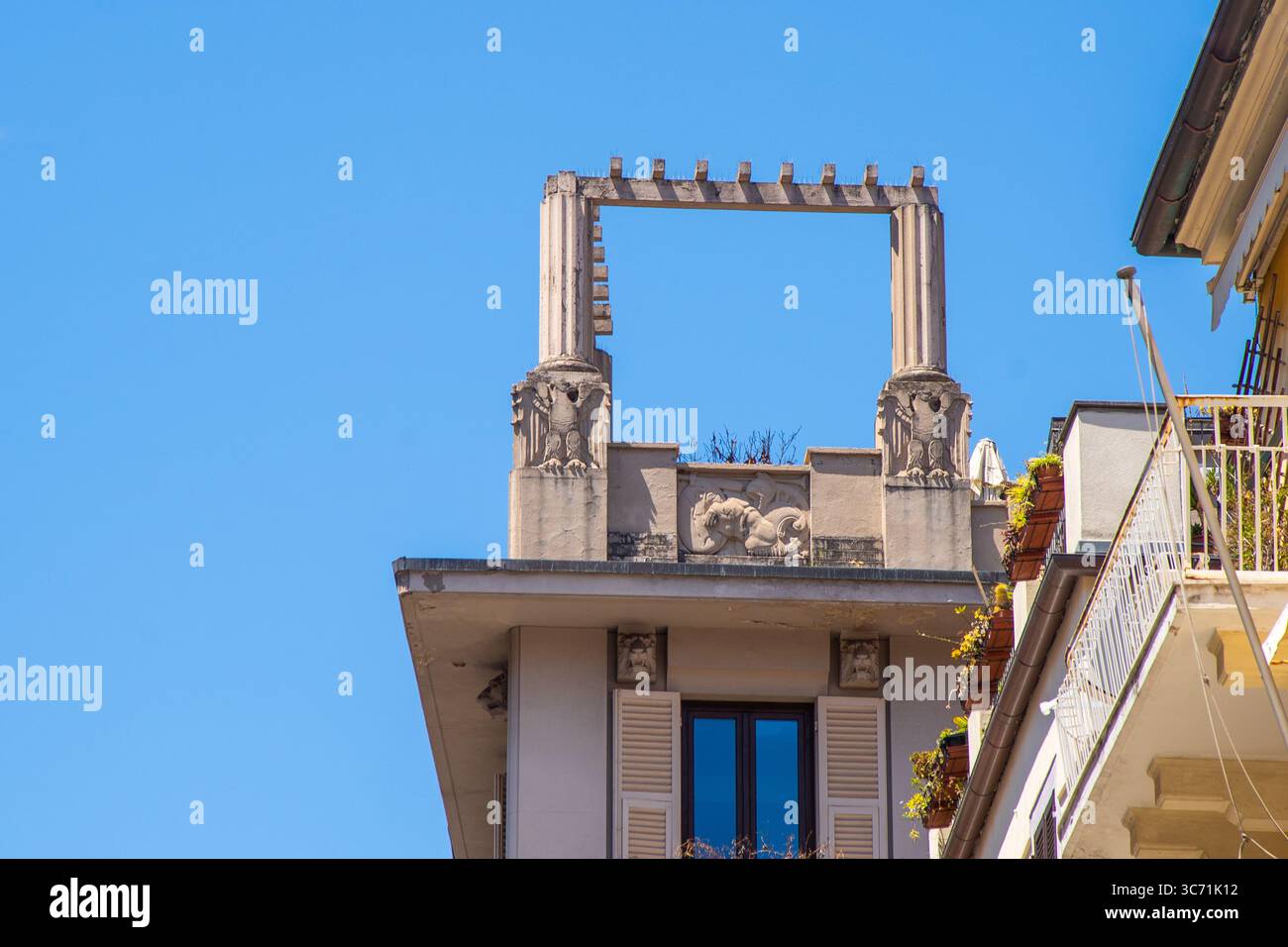 Rotonda on the roof of the house. Column with eagles and stucco balcony ...