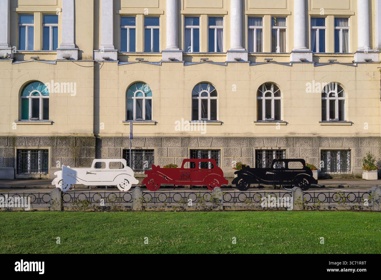Bicycle stand mimicking classic cars lines the street near historic ...