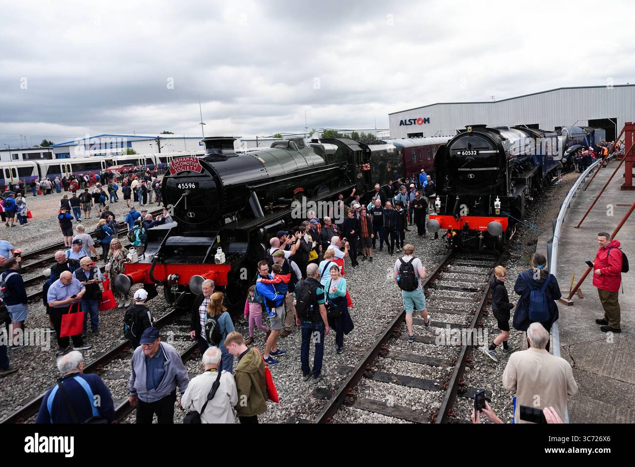 Visitors walk by and take photographs of the Bahamas steam locomotive ...