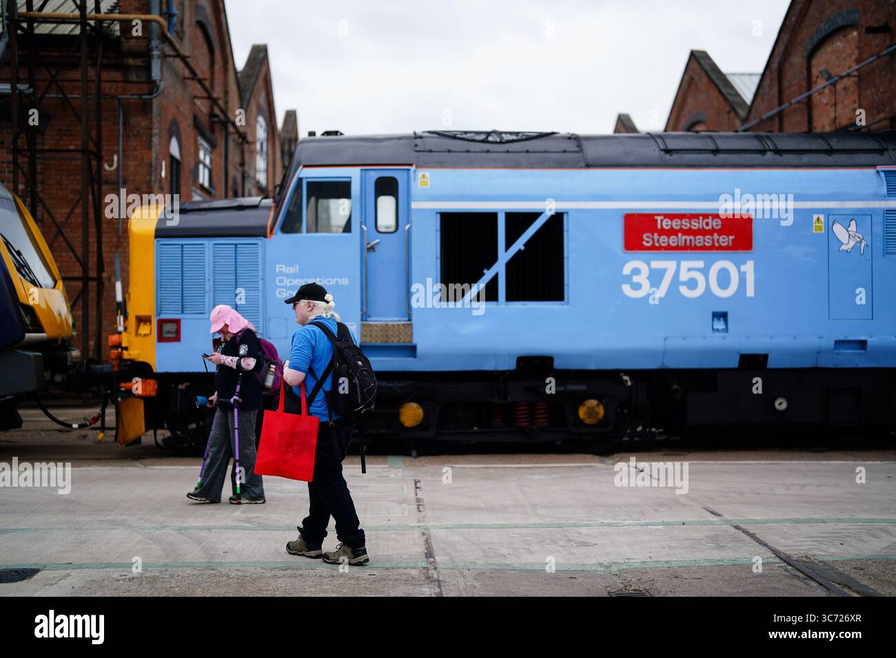 Visitors walk by the Teesside Steelmaster at Alstom's historic Derby ...