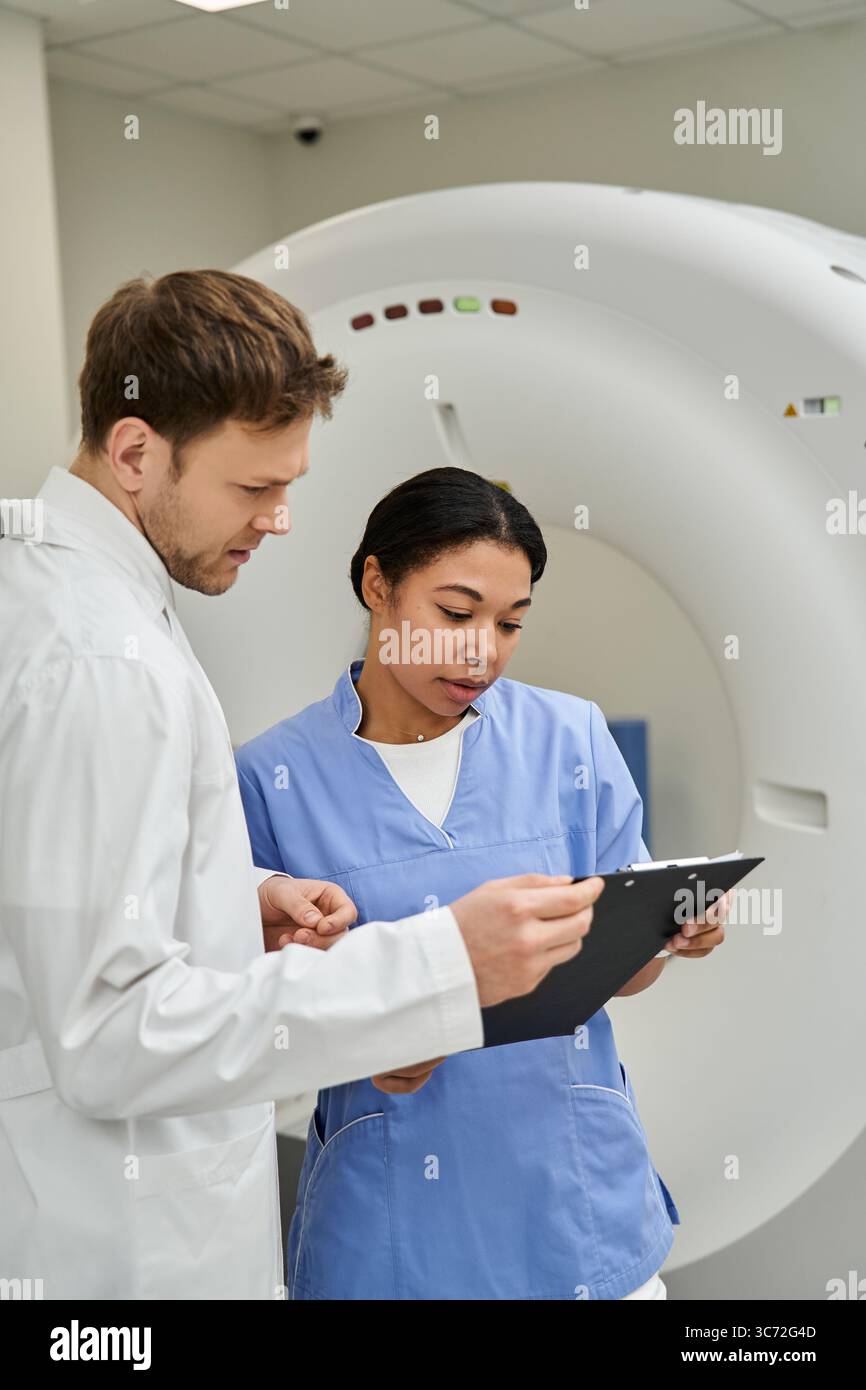 Two dedicated doctors examine MRI scan results in a high-tech hospital ...
